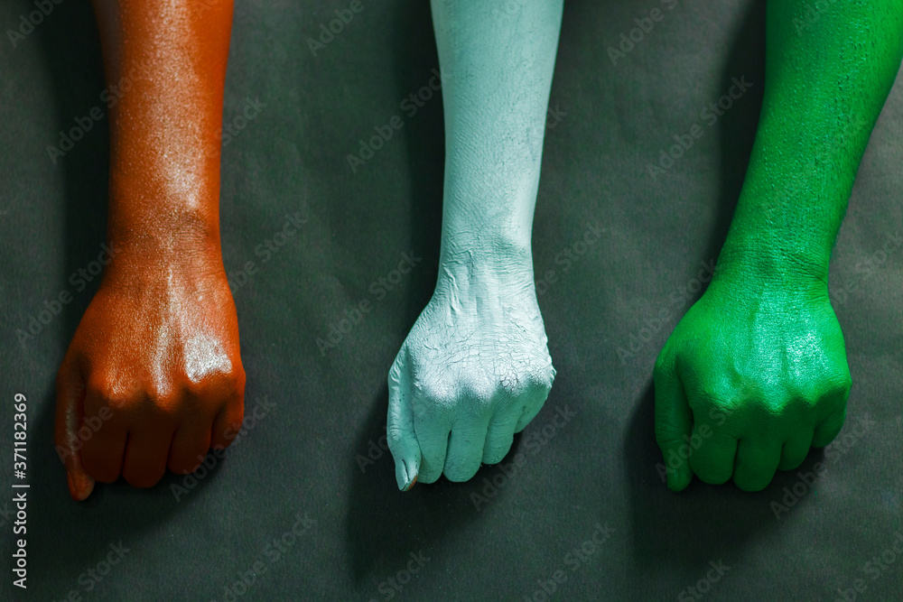 three hands are painted with three colors,saffron,white and green to ...
