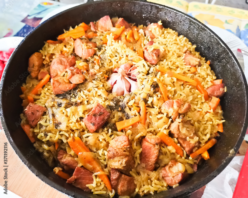 Close-up delicious pilaf in a cauldron. Appetizing Uzbek pilaf from ...