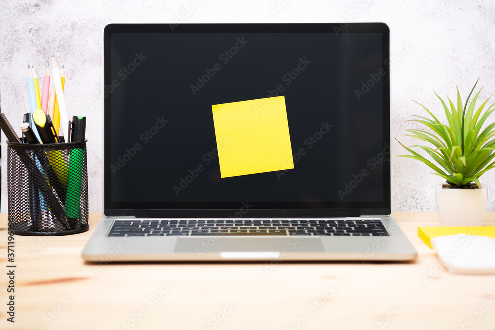 Yellow post-it on the laptop. memo paper on a screen laptop computer ...