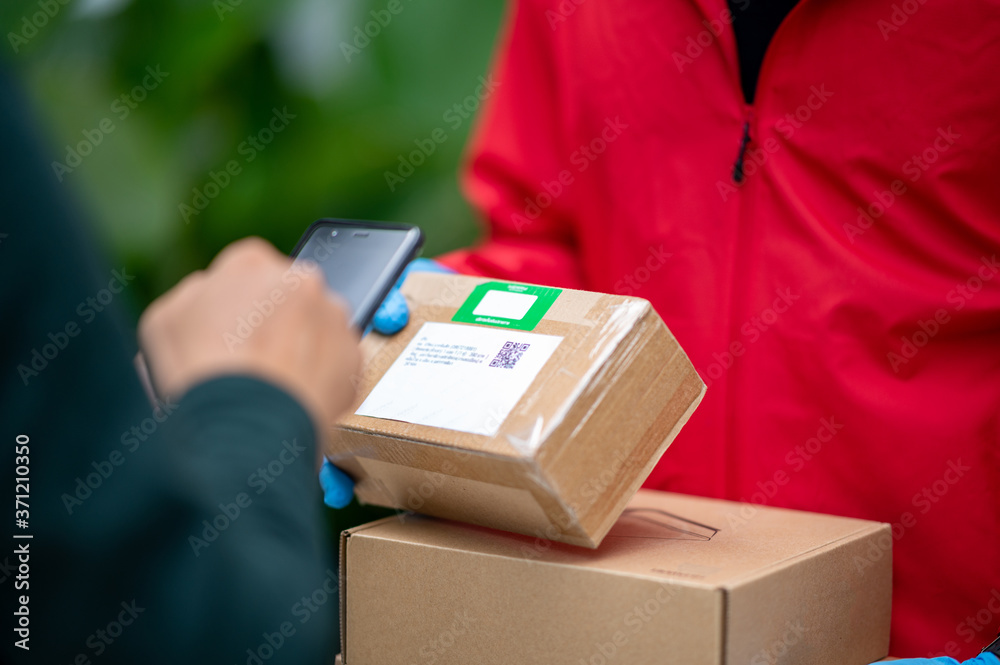 Male Customer Scanning Bar With Phone Code To Receive Products From male-customer-scanning-bar-with-phone-code-to-receive-products-from