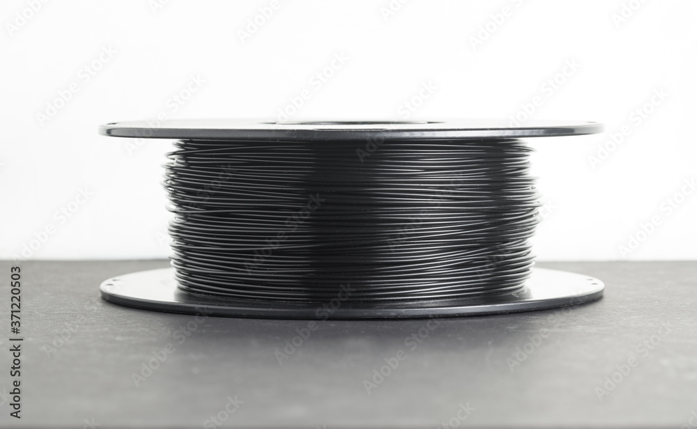 Black 3d printer filament on dark surface, and white background. 1.75 ...