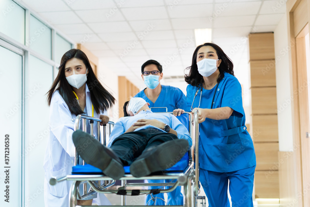 Group of Asian medics or doctors Push Stretcher with Seriously Patient ...