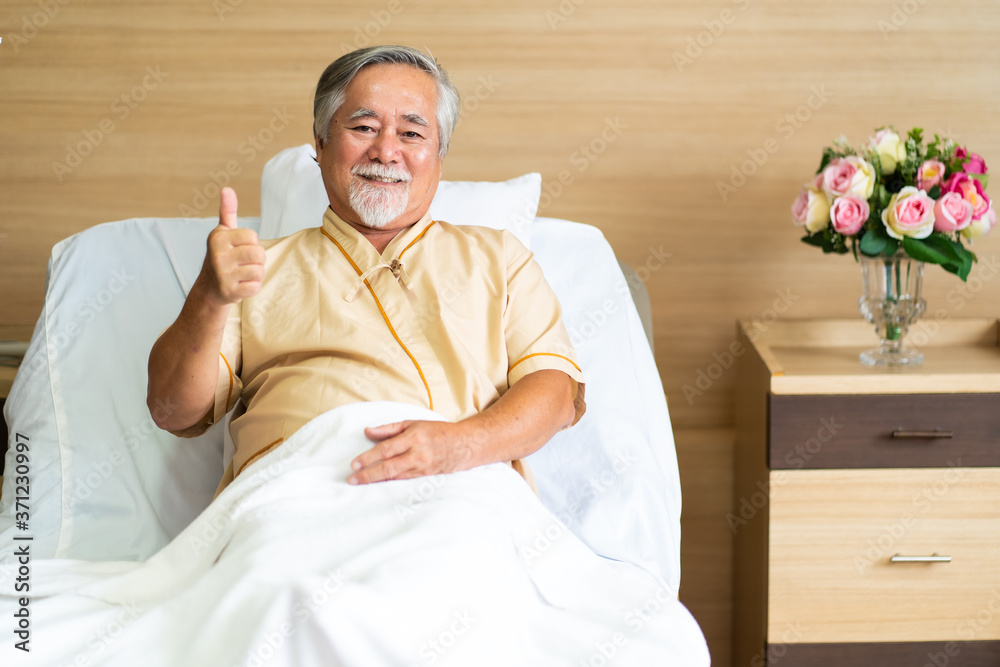 Portrait Happy Asian elderly man lying in hospital bed at clinic Stock ...