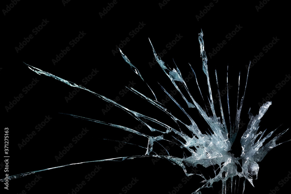 pattern from the impact of a broken mirror and glass on a black ...