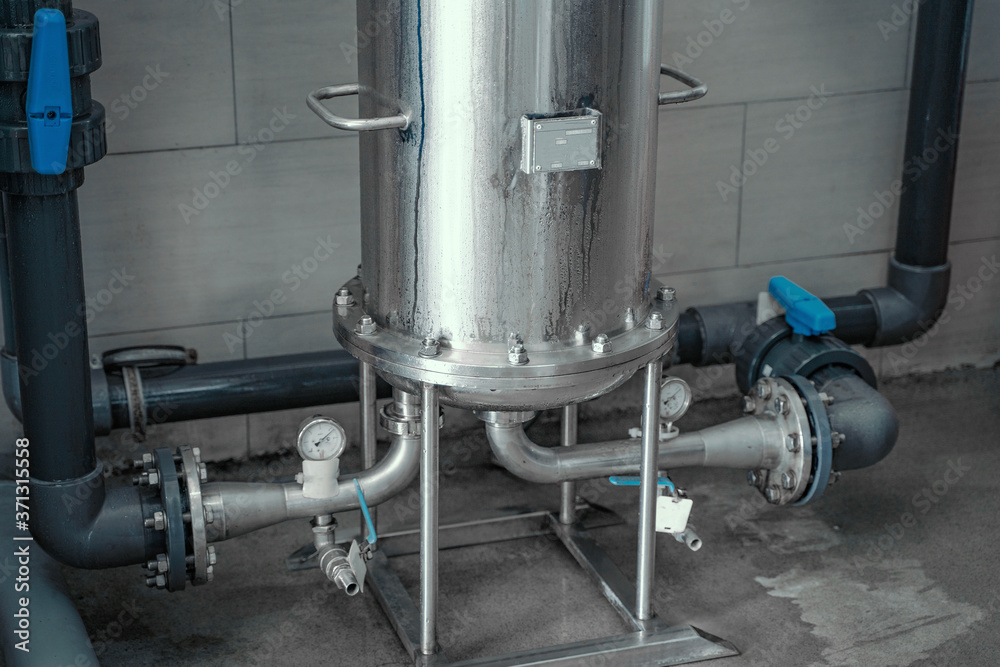 Round reservoirs or tanks with pipes for water filtration in modern ...