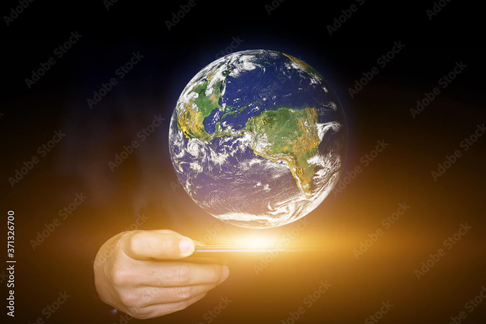 Environment concept. Hand holding smartphone with Earth on black ...