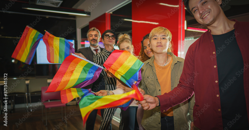 diverse group of lgbtq people with rainbow flag on hand team up ...