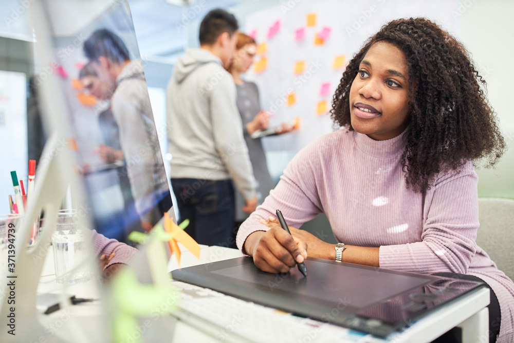 Woman as a graphic designer designs a layout Stock Photo | Adobe Stock
