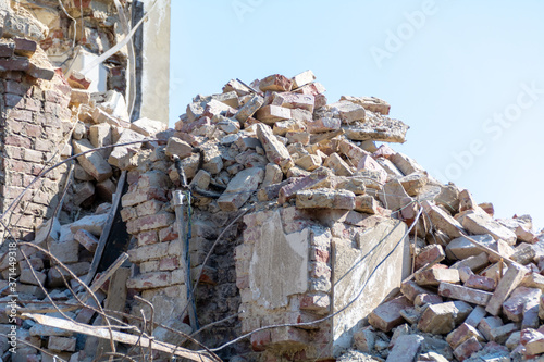 Ruined building. A pile of concrete, rubble and reinforcement debris ...
