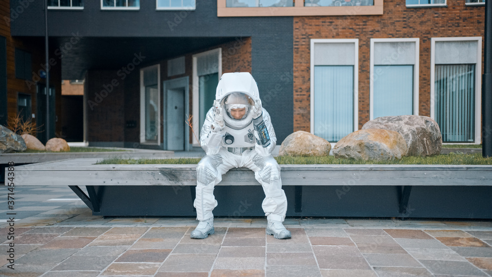 Sad Man in Spacesuit is Sitting on Wooden Bench. Miserable Astronaut ...