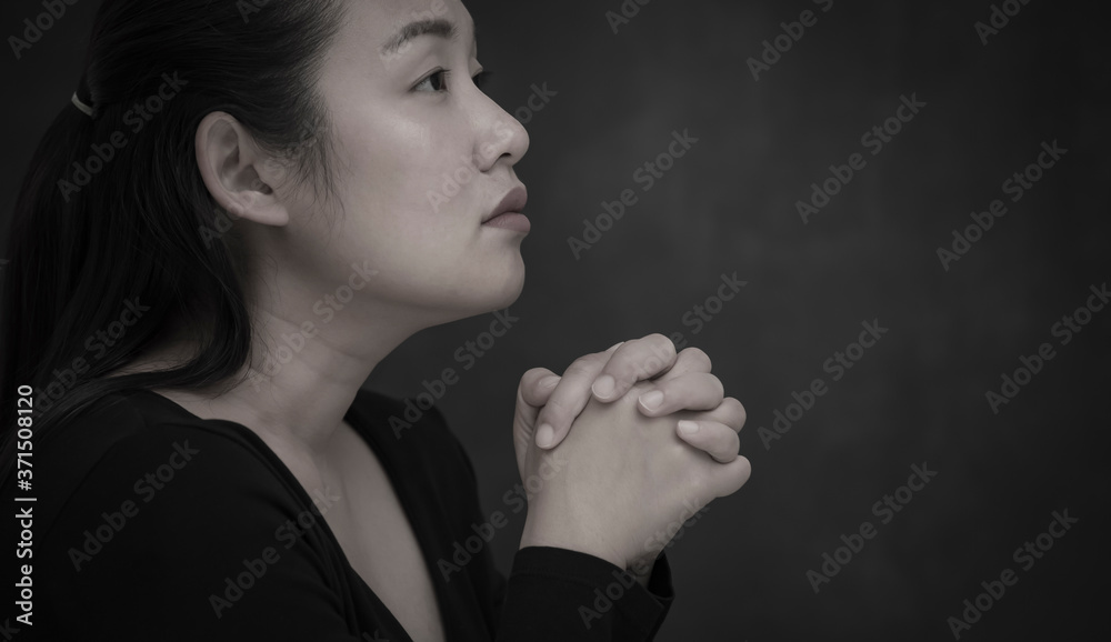 Asian face woman praying and worship to GOD Using hands to pray in religious beliefs and worship ...
