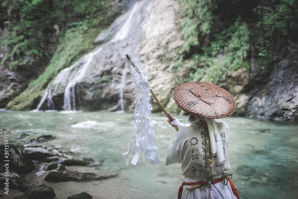 European yamabushi monk in traditional shugendo robe does water ...