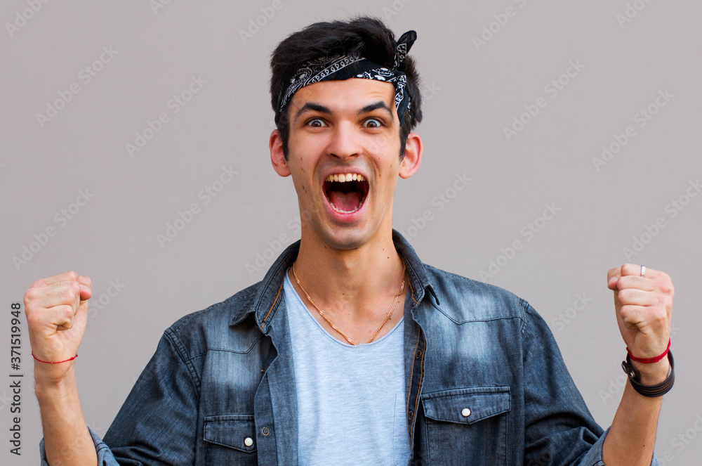 Young man isolated on gray studio background, facial expression ...