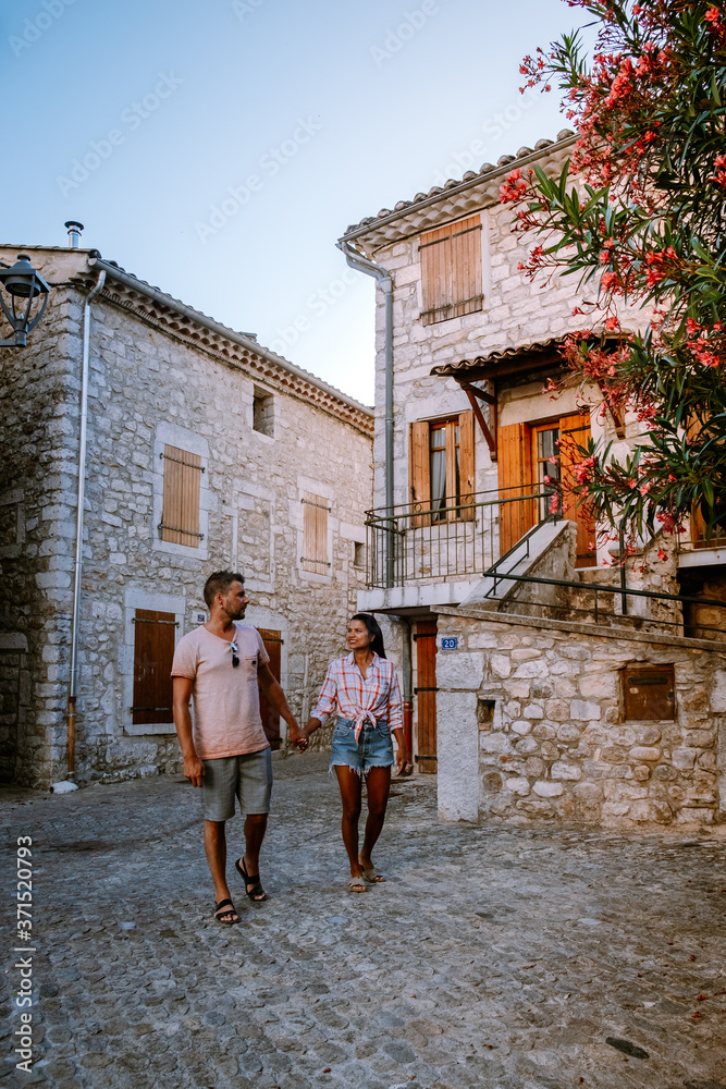 couple visit Ruoms, The medieval village of Ruoms with its old brick ...