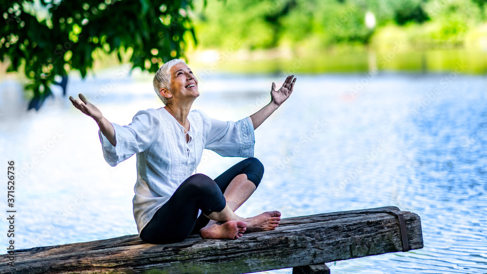 Beautiful mature woman enjoying peace and tranquility of the nature ...