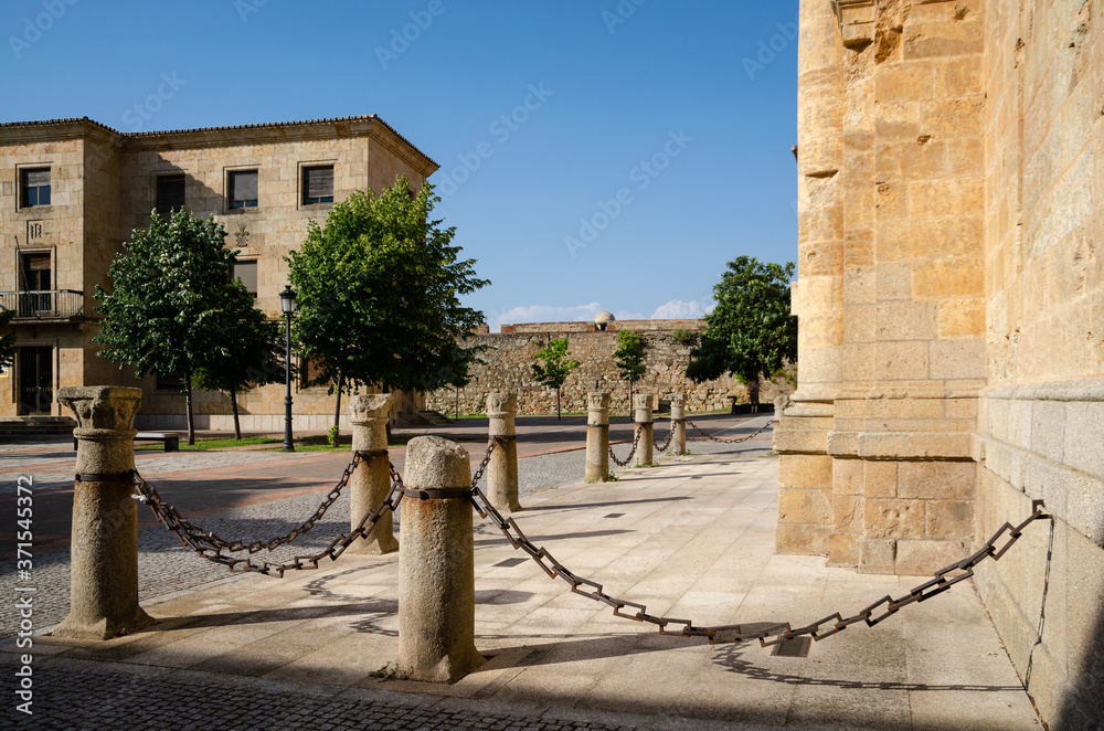 Fence made of natural stone pillars with metal chains embedded in the ...
