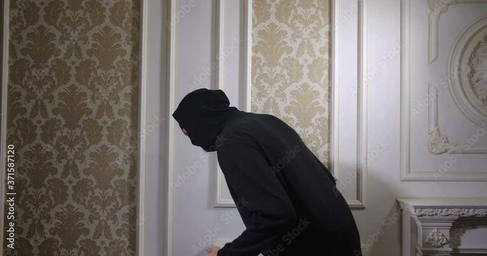 Robbery of the museum. Man in black clothes and balaclava is caught in ...