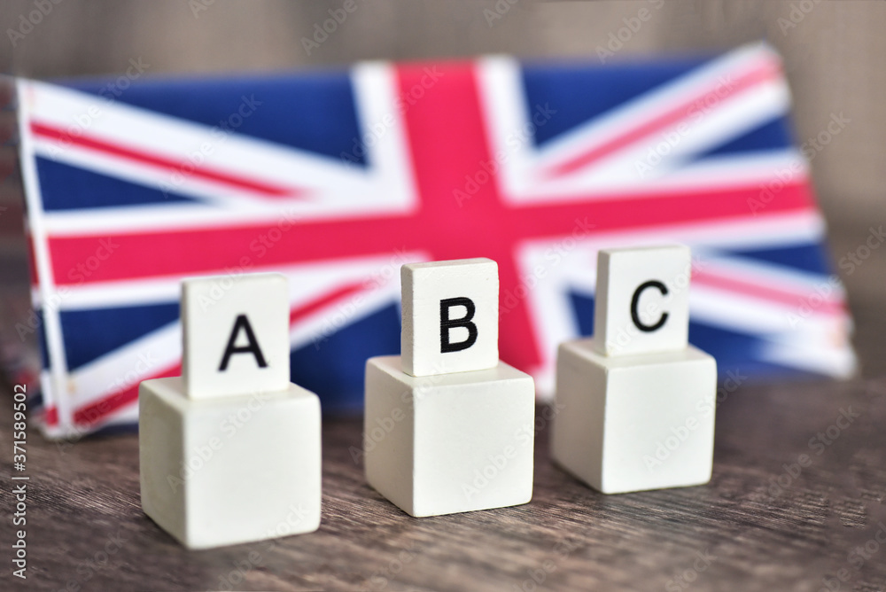 English wooden alphabet block with England flag symbol background ...