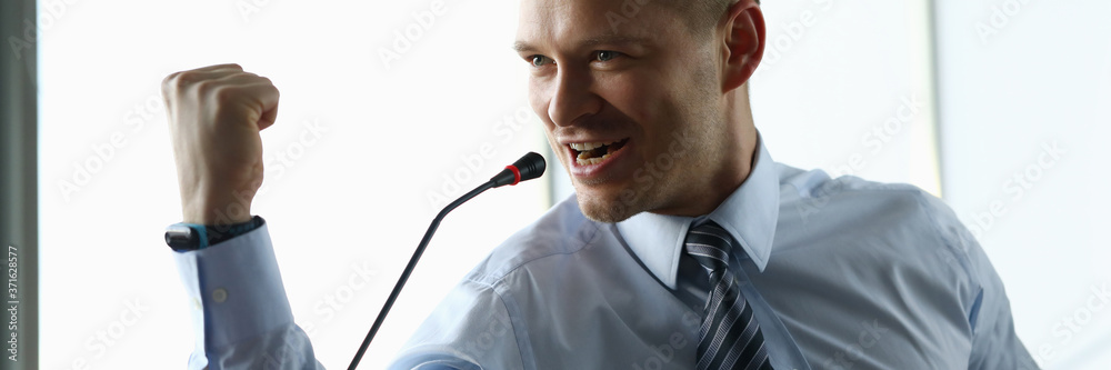 Portrait of confident man in presentable suit public speaking with ...