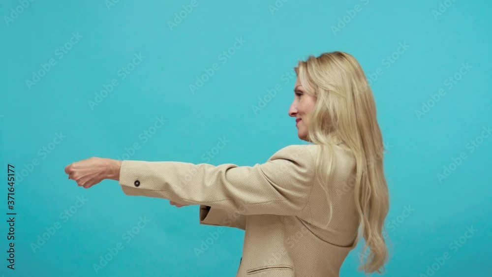 Profile portrait assertive purposeful blond adult woman pulling ...