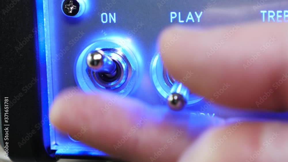 Rock musician starts to play electric guitar, takes the guitar, puts ...