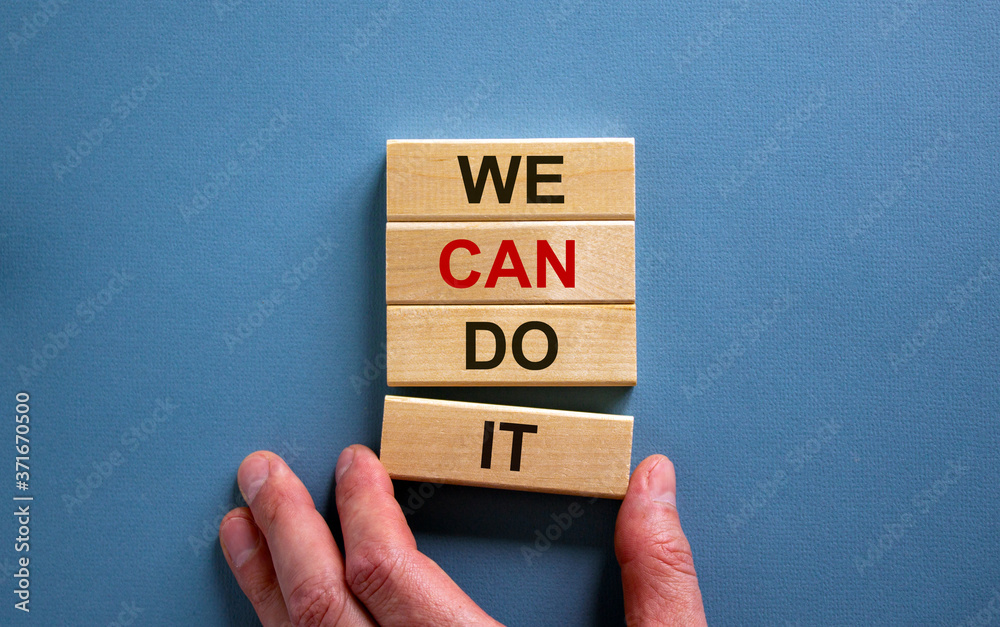 Male hand placing a block with word 'it' on a blocks tower with words ...