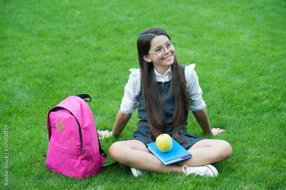 The best time to take break. Happy child relax on green grass. School ...