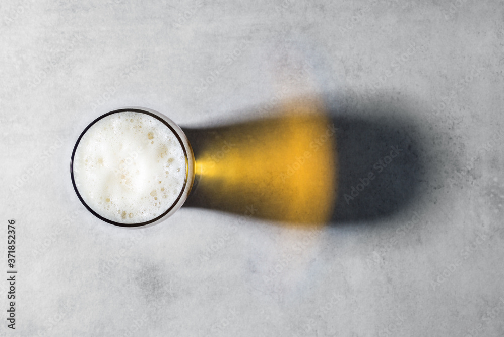 beer glass and shadows top view Photos | Adobe Stock