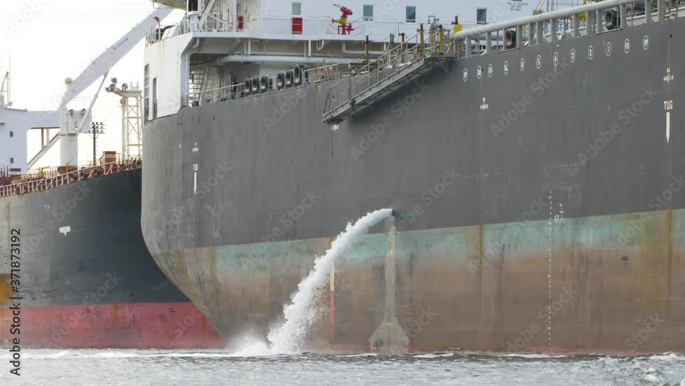 Water flushes out of cargo ship Foremast, forecastle and mooring system ...