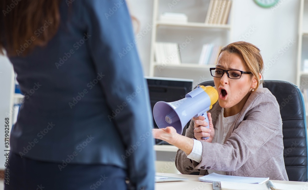 Angry woman boss yelling at her female employee Stock Photo | Adobe Stock