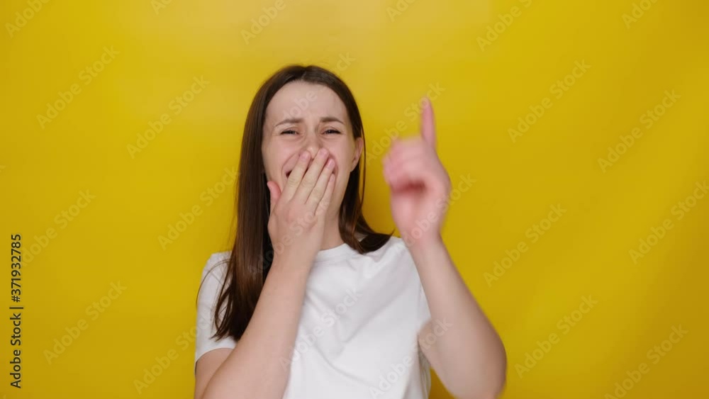 Amused happy millennial young woman isolated on yellow studio ...