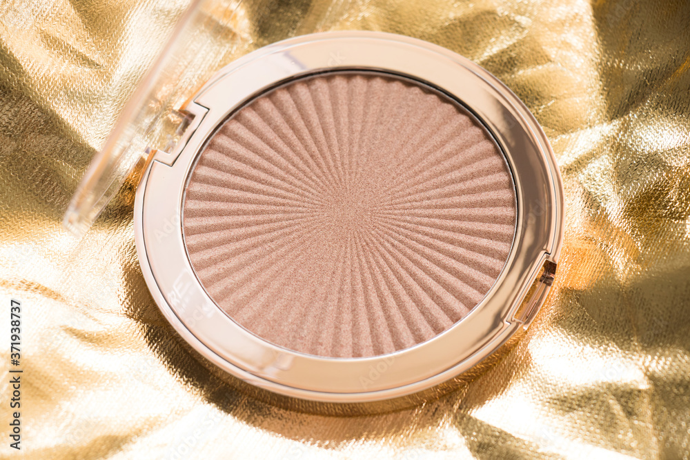Background with gold background and highlighter. For makeup on a gold ...