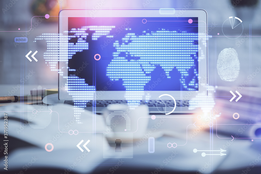 Double exposure of desktop with computer and world map hologram ...