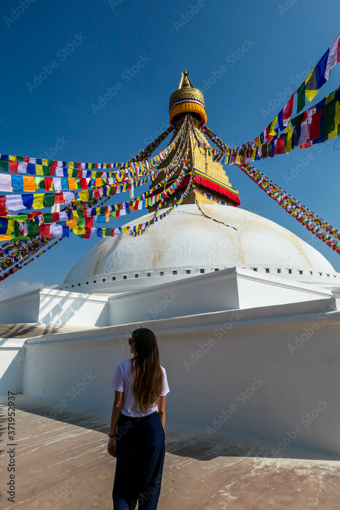 A woman standing under Bouddhanath Temple in Kathmandu, Nepal. The ...