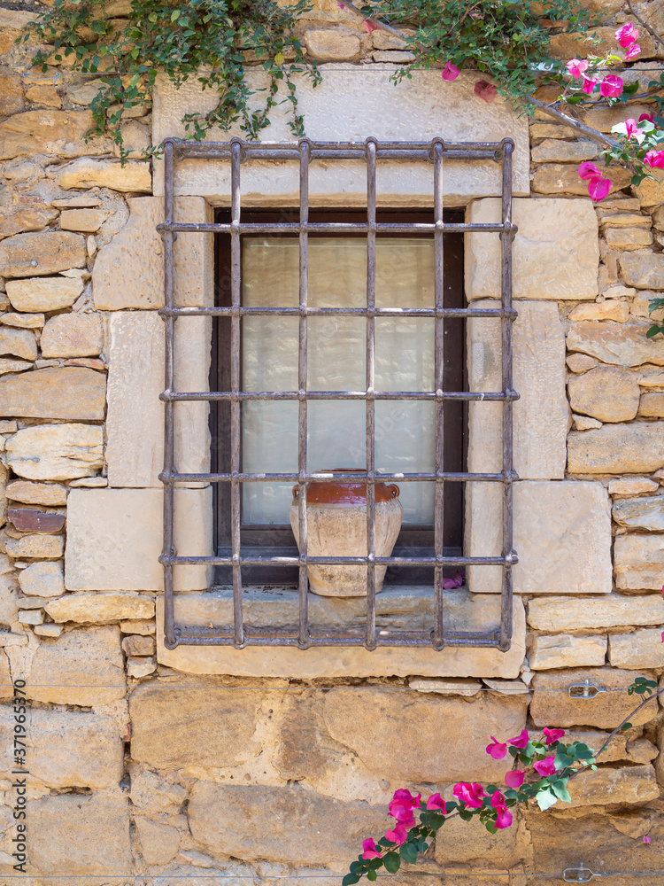 Medieval window with the grill and flowers of a dwelling house Stock ...