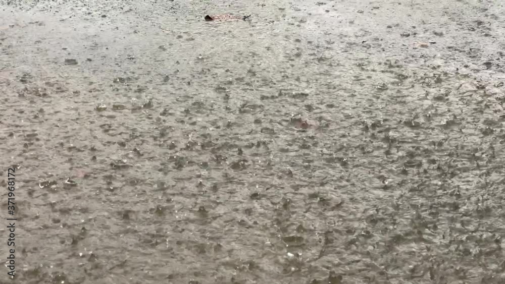 4K-Slow Motion, rain water drops falling into big puddle on old ...