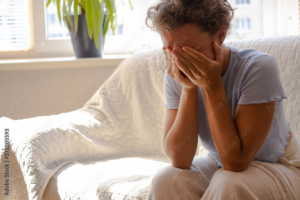 Sad depressed young brunette woman covering face with her hands,crying ...