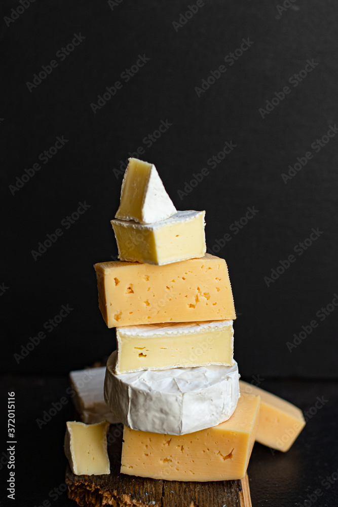 cheese assortment of different types of hard and soft cheeses serving ...