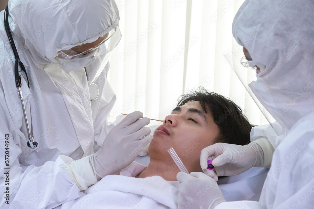 male nurse and doctor wearing ppe suit and facemask perform Coronavirus ...