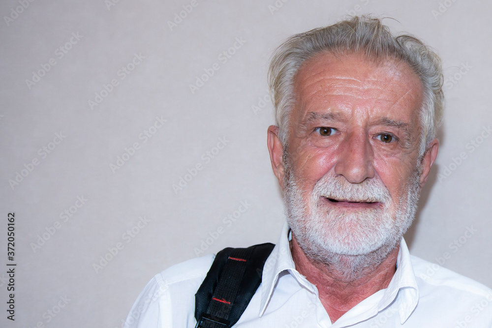 Portrait of confident optimist old man with beard wrinkled face wearing ...