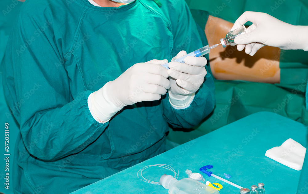 Anesthesiologist or doctor hold syringe prepare for injection in ...