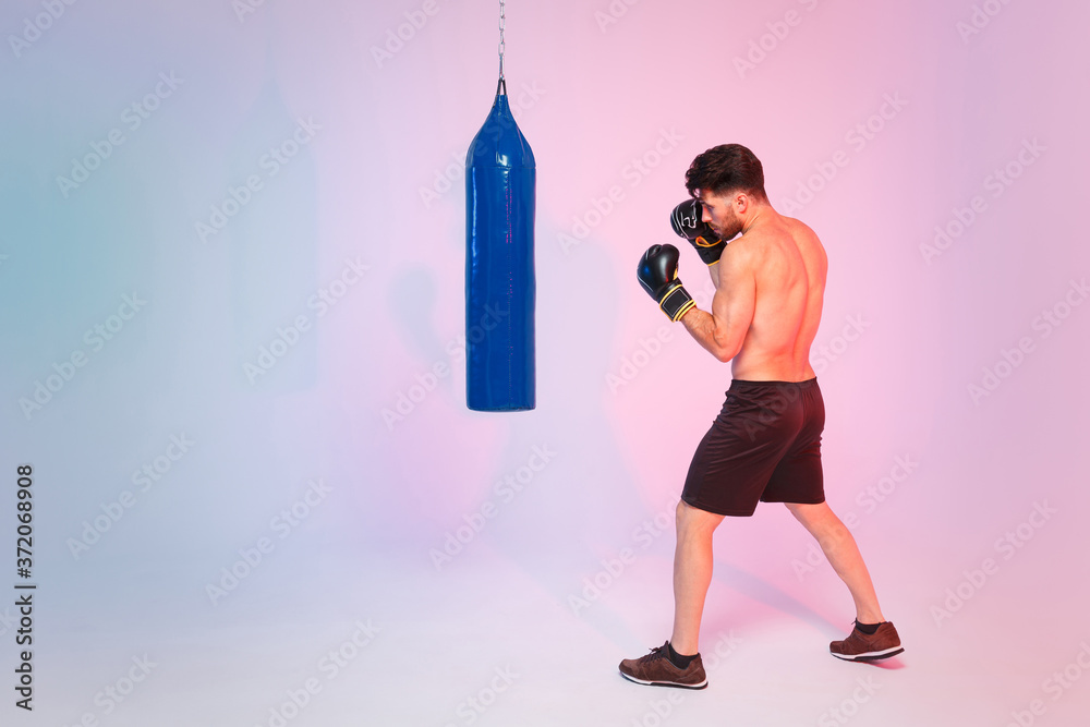 Full length portrait side view young guy bare-chested sportsman boxer ...