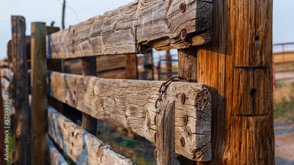 Old wooden fence post and fencing on a working farm near Denver on a ...