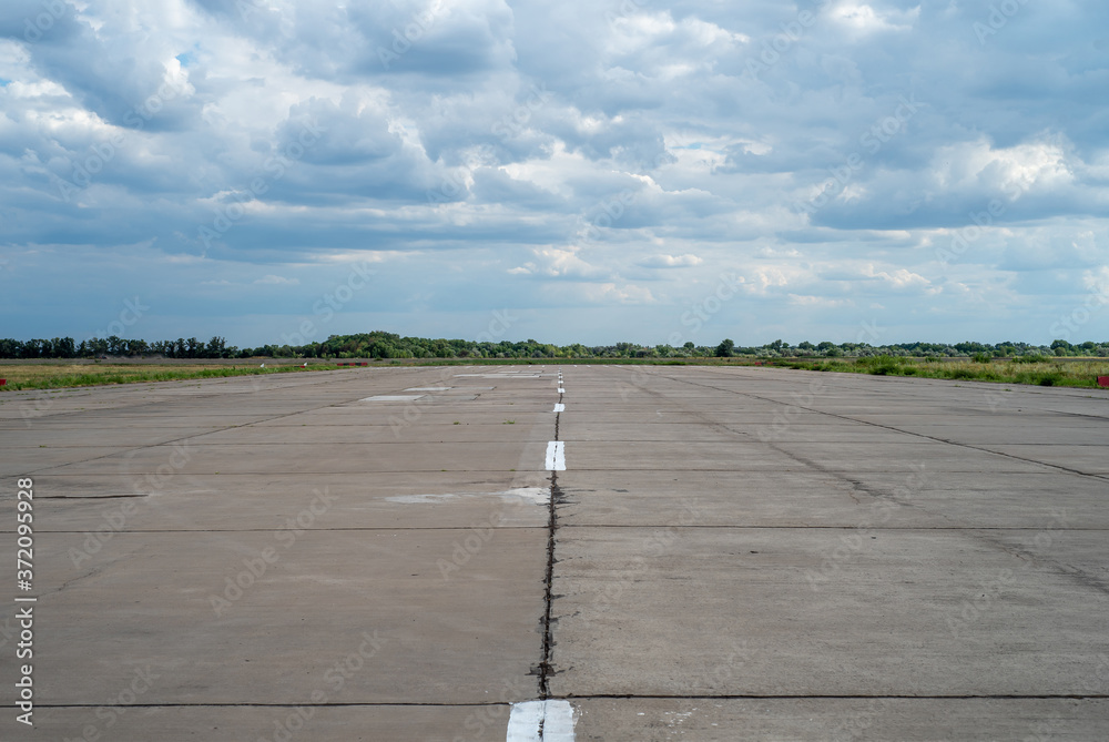 Empty runway strip and cumulus. Military transport airfield Kryvyi Rih ...