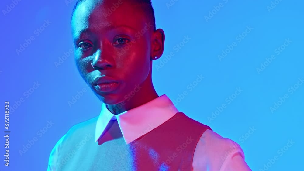 Close-up of a beautiful Black model as she turns to look into the ...