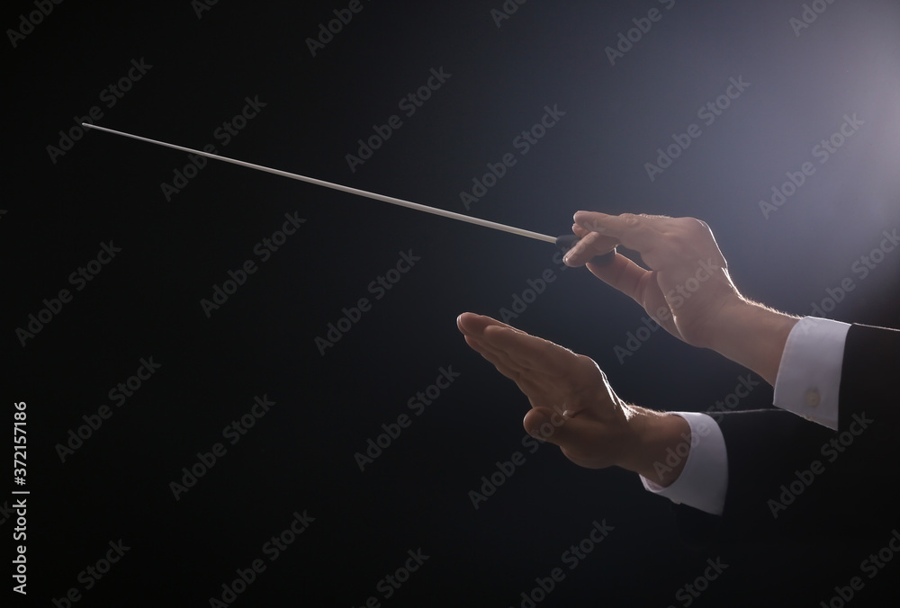 Hands of male conductor on dark background Stock-Foto | Adobe Stock