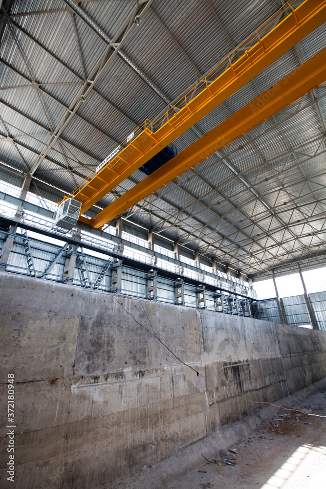 Grey concrete interior of new industrial building. New factory workshop ...