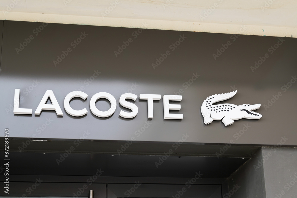 lacoste sign and text logo front of store famous french chain of luxury ...