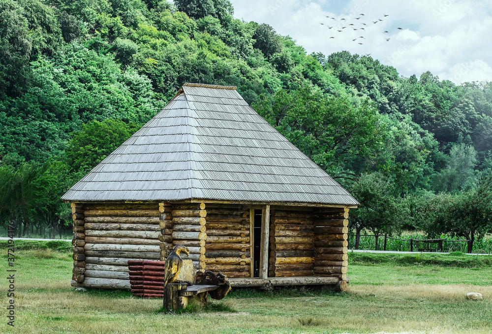 Simple, poor wooden house located in a beautiful landscape, near the ...