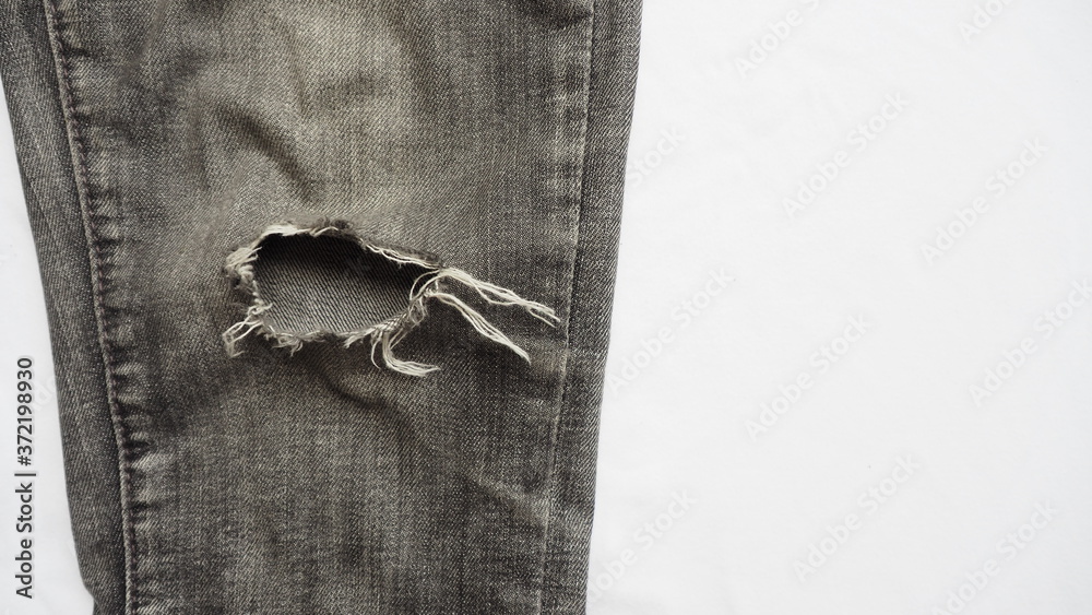 Top view of the old black jeans cracked with big hole Need to repair by ...